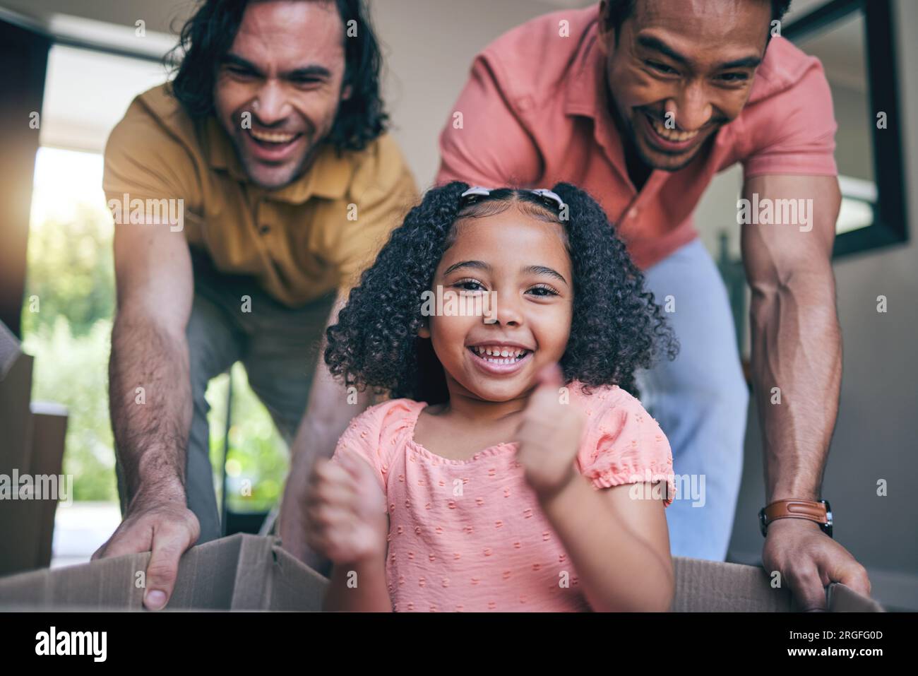 Family home, girl and box with parents, push and gay dad with games ...