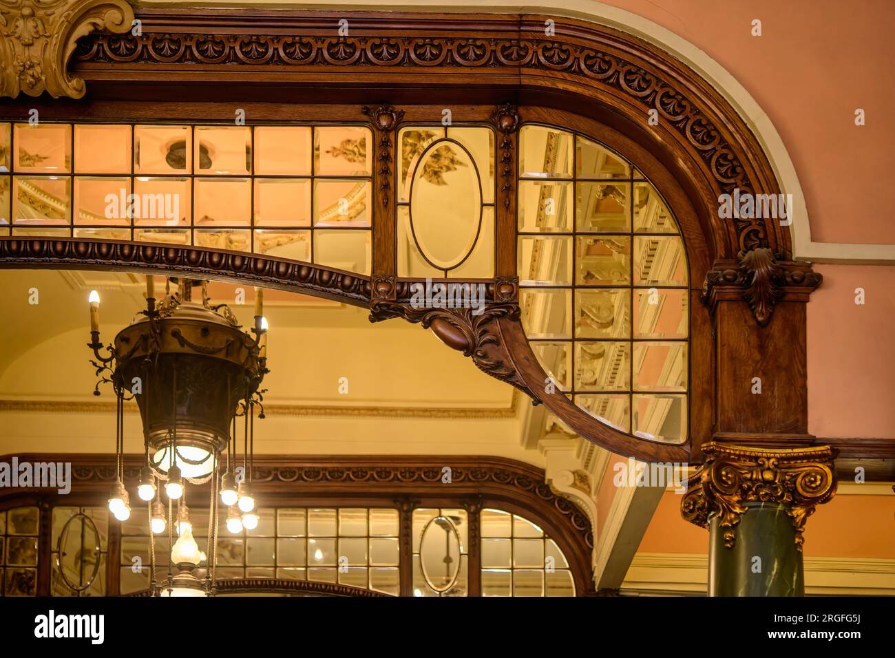 Precious wood and glass decorating a large arched door in the main hall ...