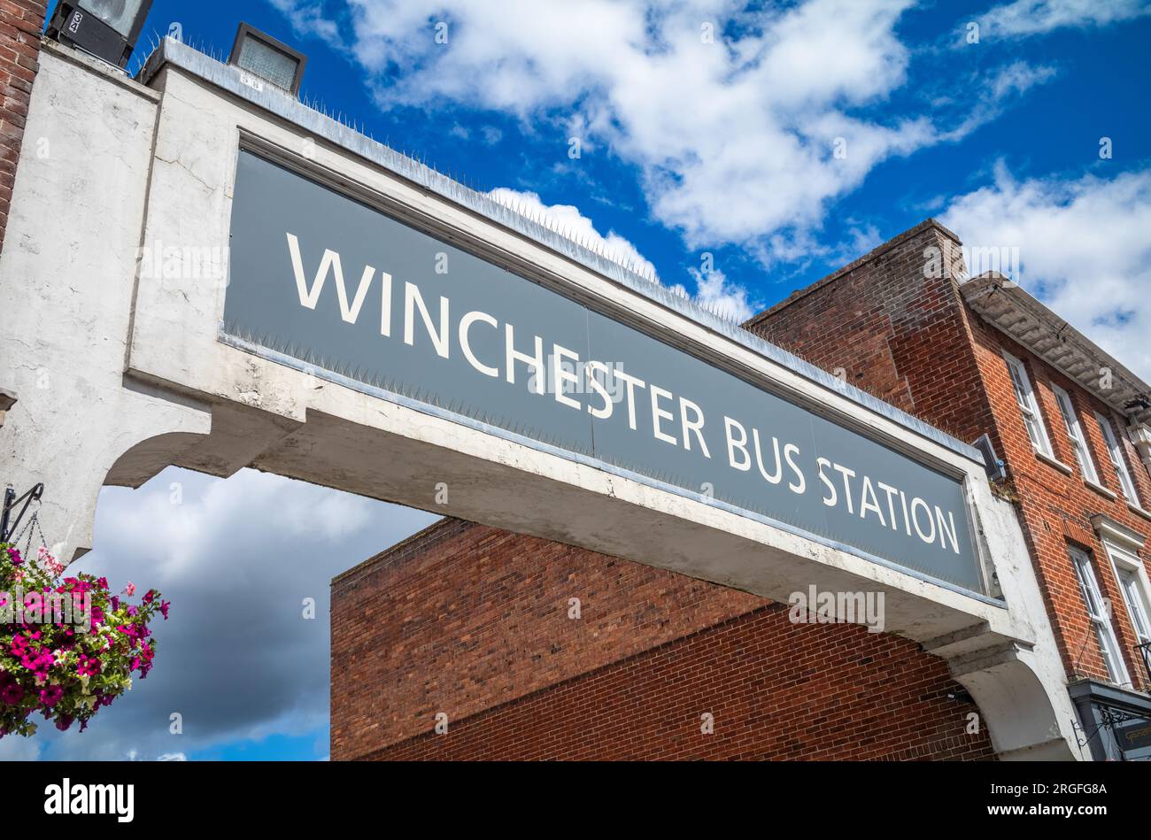A large concrete sign reading "Winchester Bus Station" in white letters ...