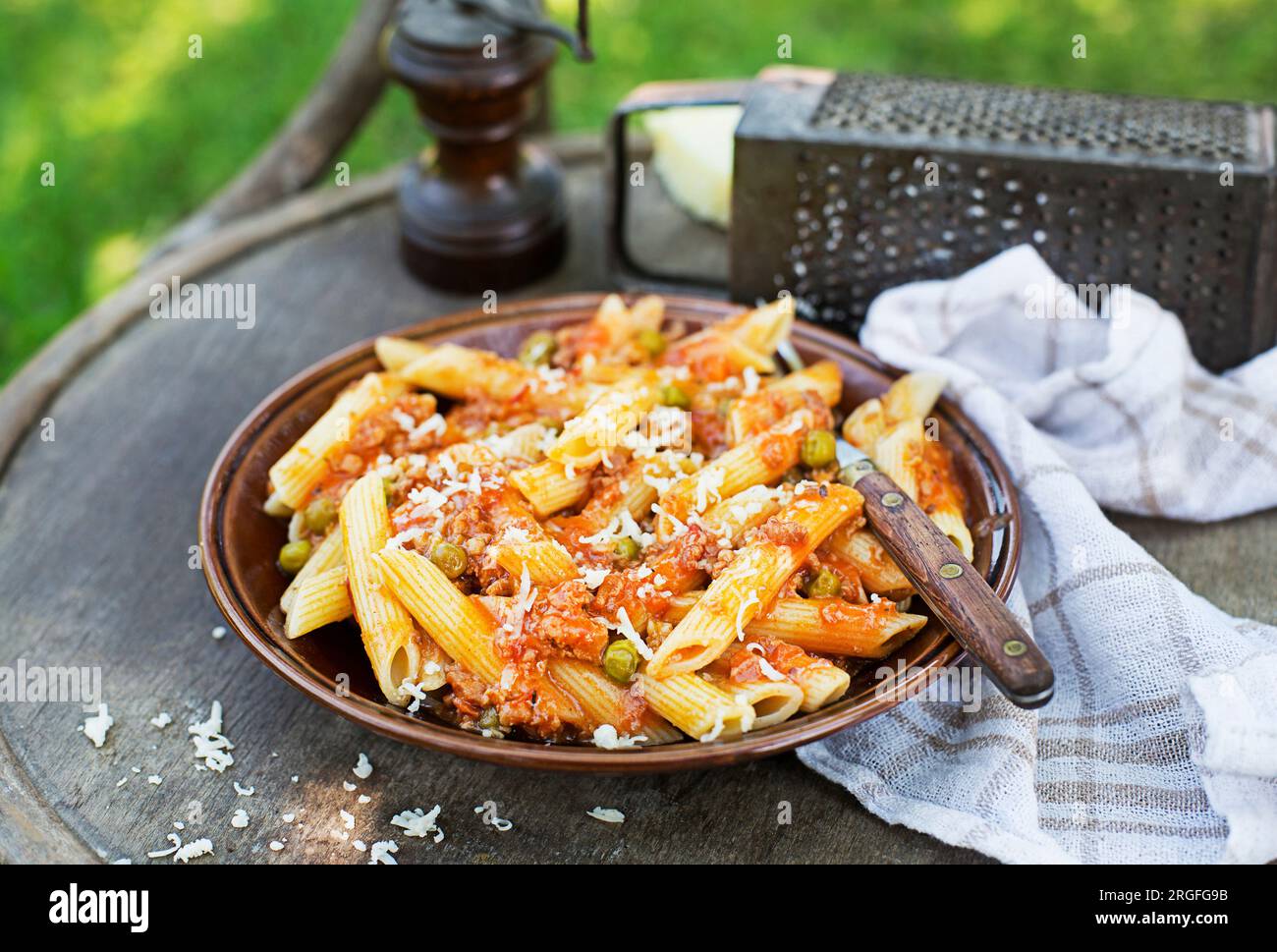 Penne pasta in tomato sauce with meat, bolognese sauce. Eating ...