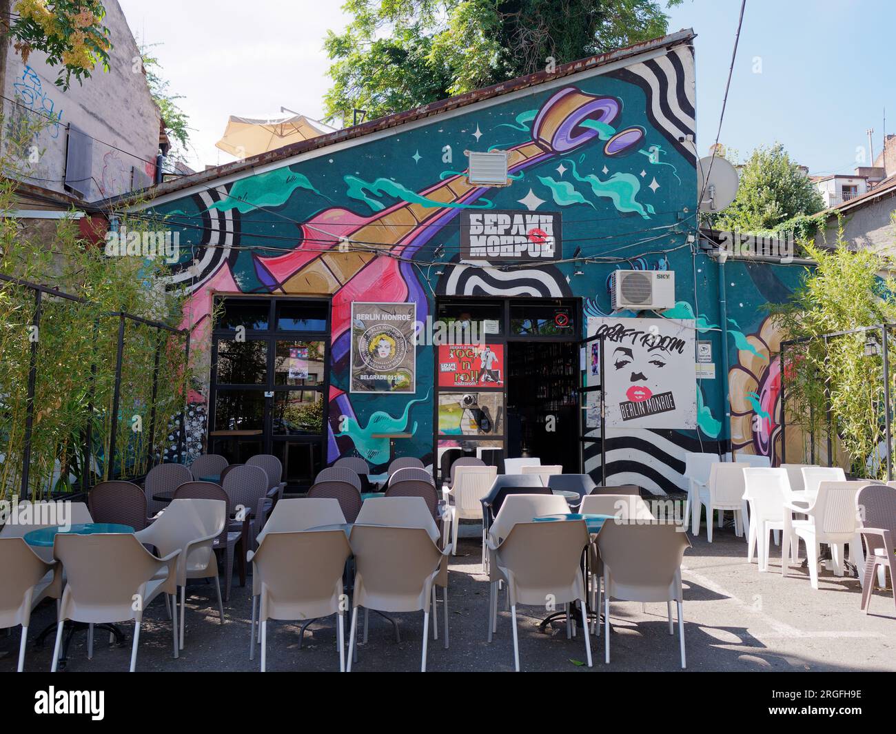 Trendy cafe with illustration of a guitar on the front and plastic ...