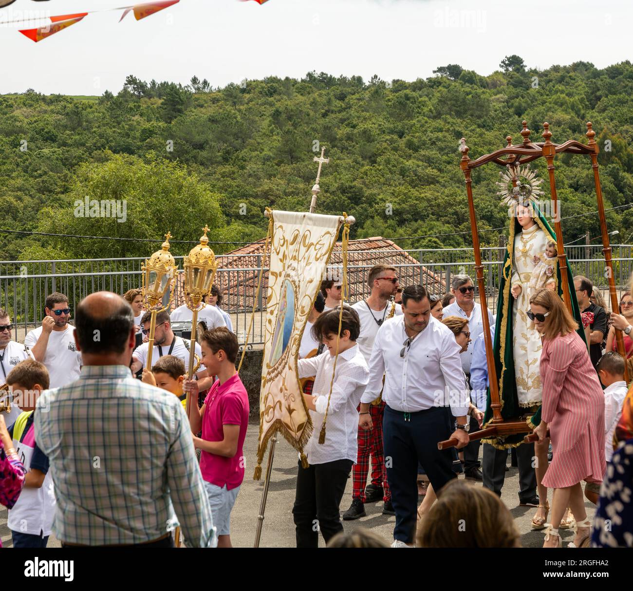 Village fiesta procession of villagers with statue of Virgin Mary ...