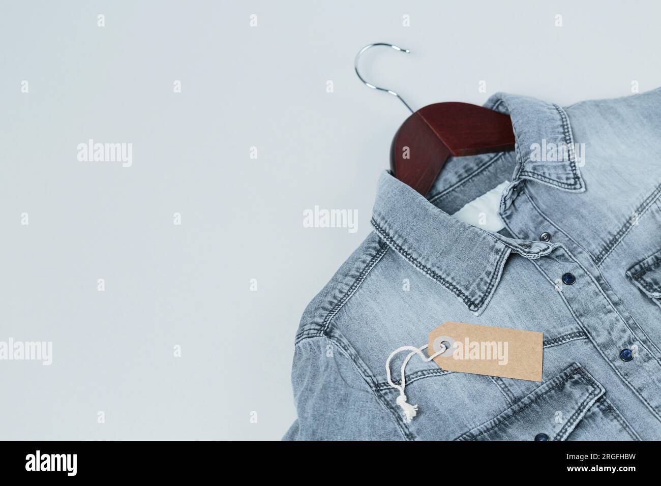 Gray denim shirt with empty tags on hanger on white background Stock ...