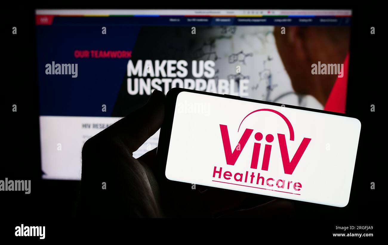 Person holding smartphone with logo of British pharmaceutical company ...