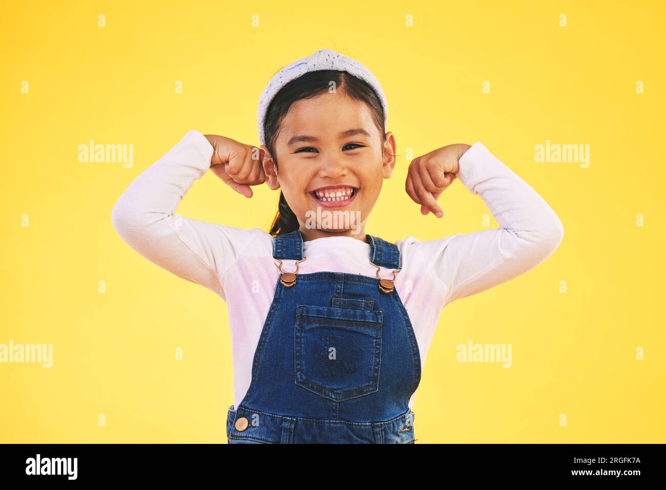 Smile, portrait and girl child with arm flex in studio for confidence ...