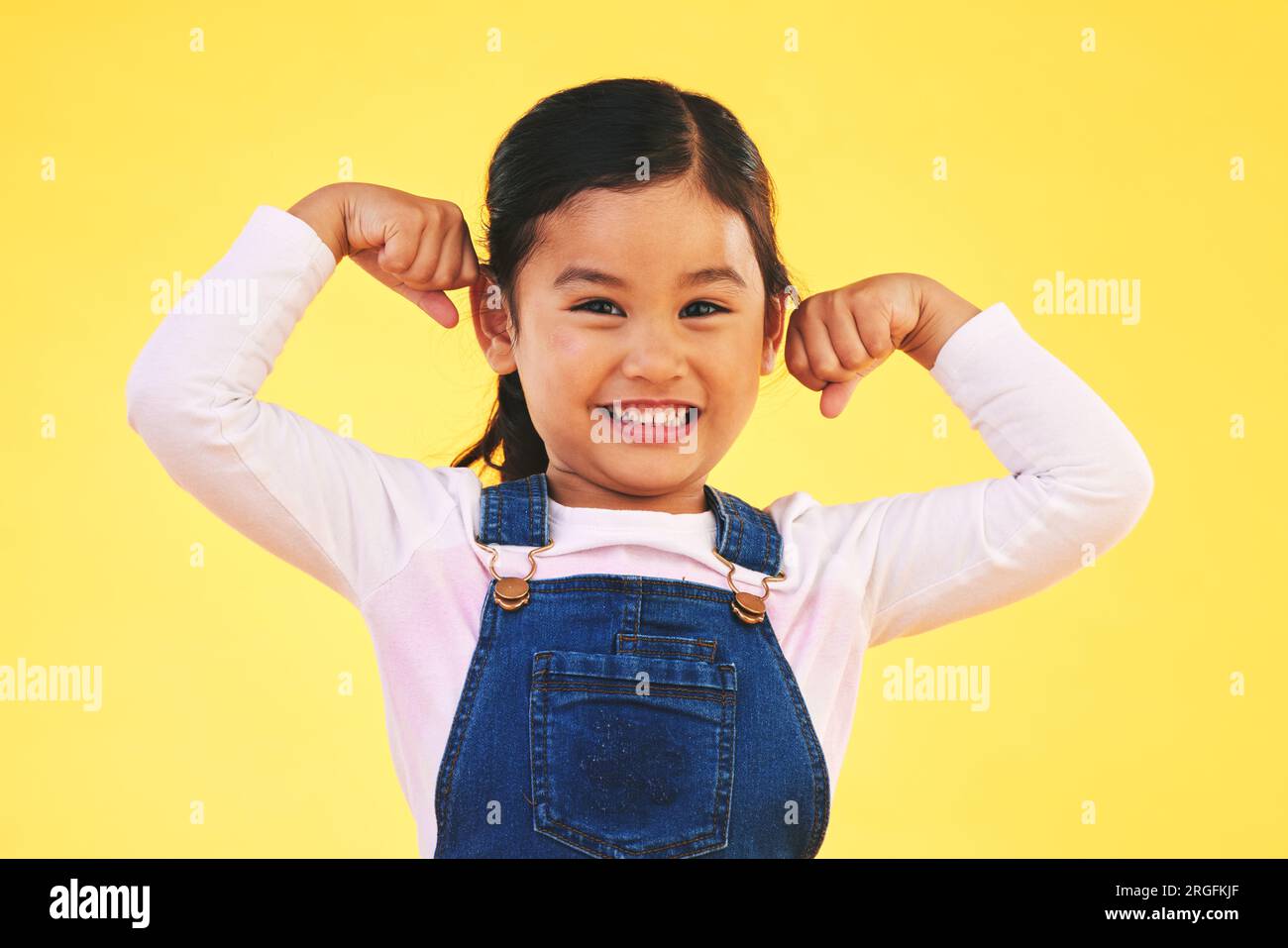 Happy, portrait and girl child with arm flex in studio for confidence ...