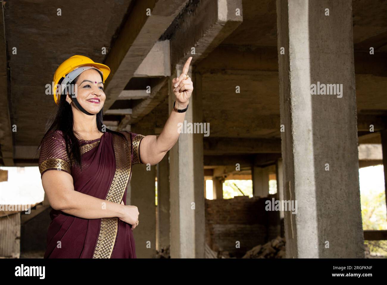 Portrait of confident young beautiful Indian female civil engineer or ...