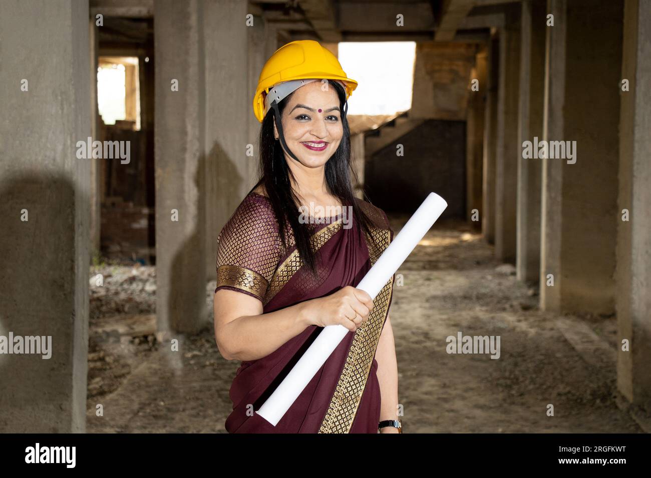 Portrait of confident young beautiful Indian female civil engineer or ...