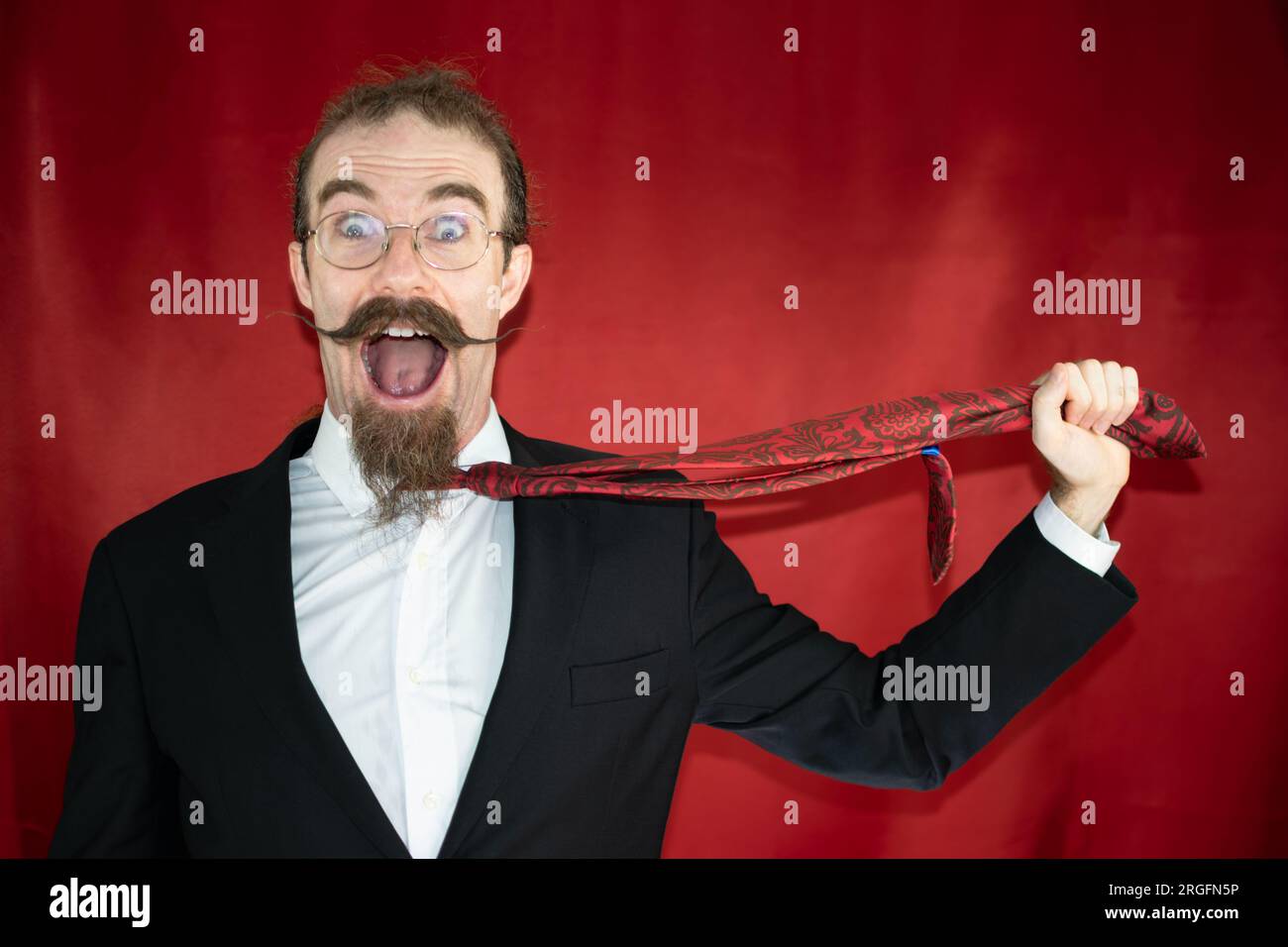 Funny man pulling his tie screaming while expressing various emotions ...
