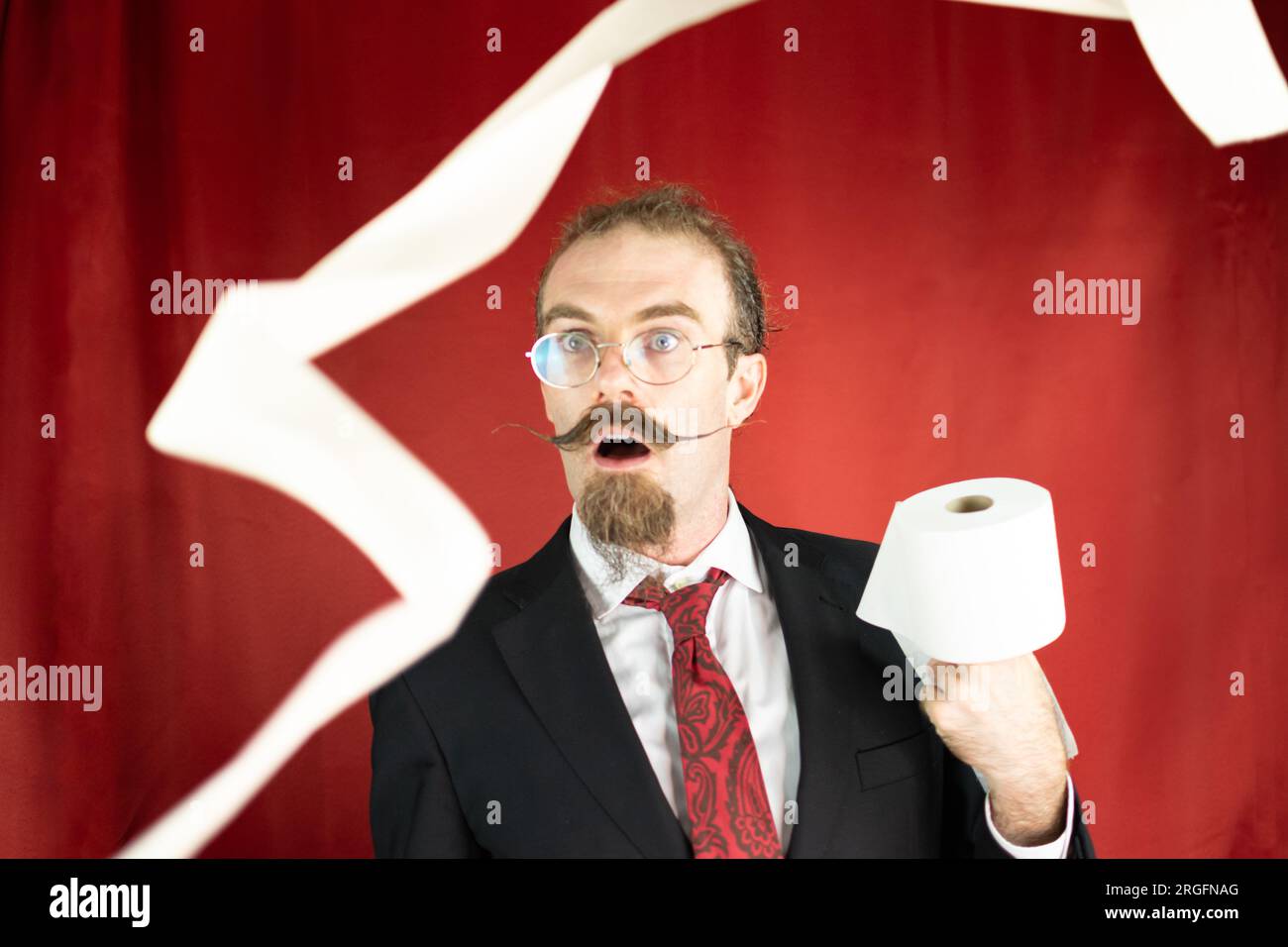 Shocked man with glasses, red tie and toilet paper in hand looking how ...