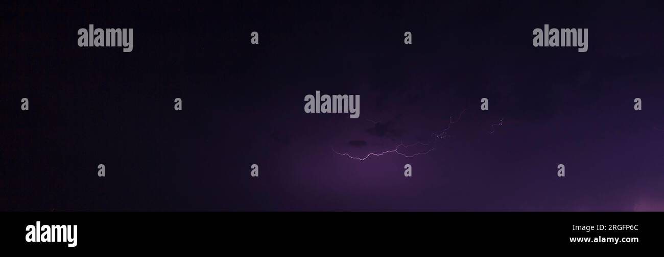 Picture of a flash in the night sky with glowing clouds in summer Stock ...