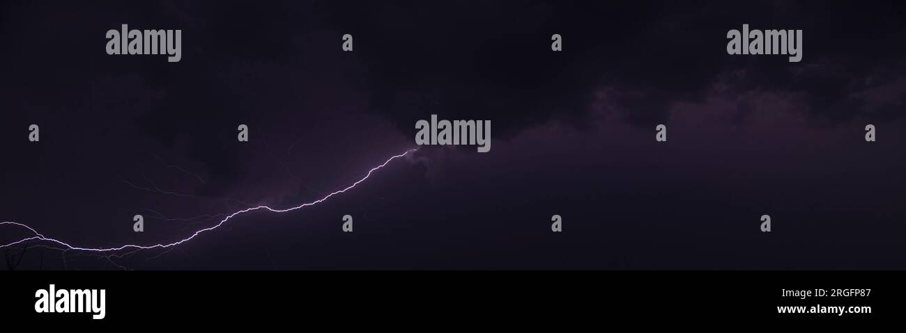 Picture of a flash in the night sky with glowing clouds in summer Stock ...