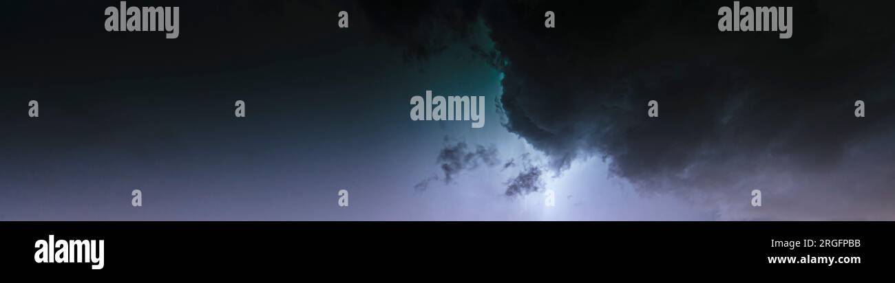 Picture of a flash in the night sky with glowing clouds in summer Stock ...