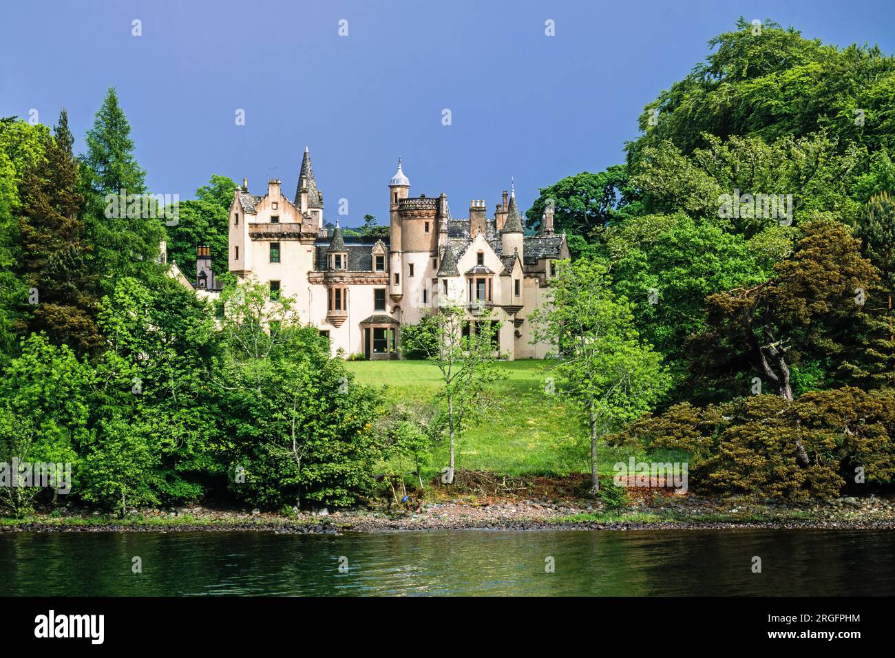 Scottish castle by a lakeshore in the forest Stock Photo - Alamy