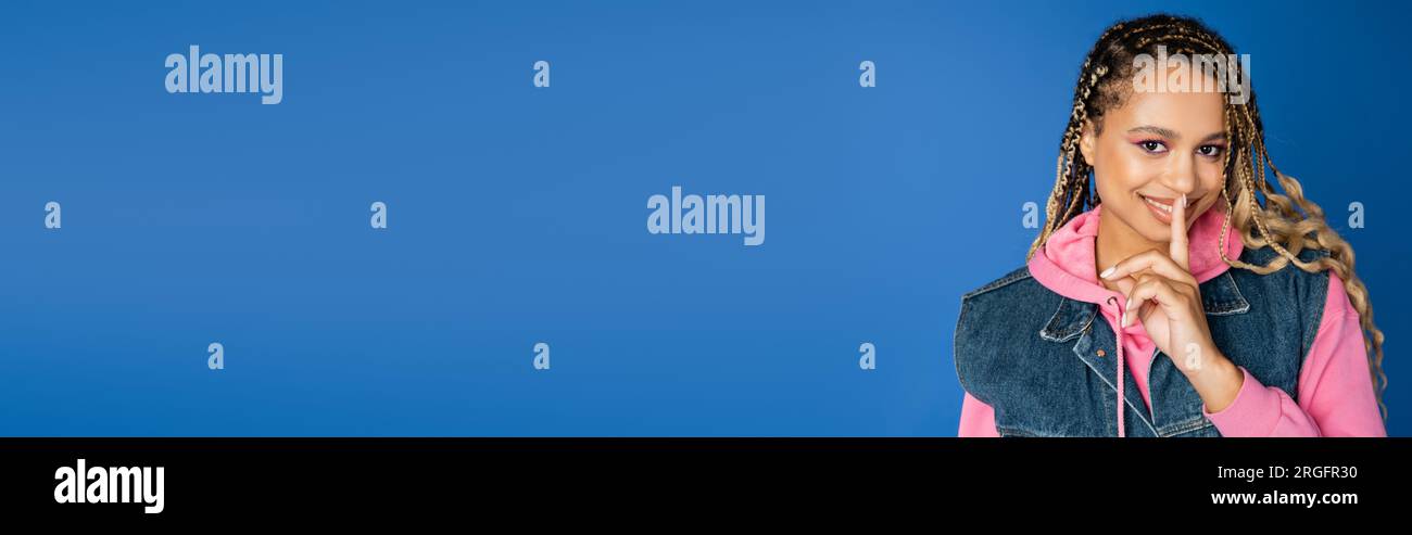 banner, happy african american woman with dreadlocks showing hush sign ...