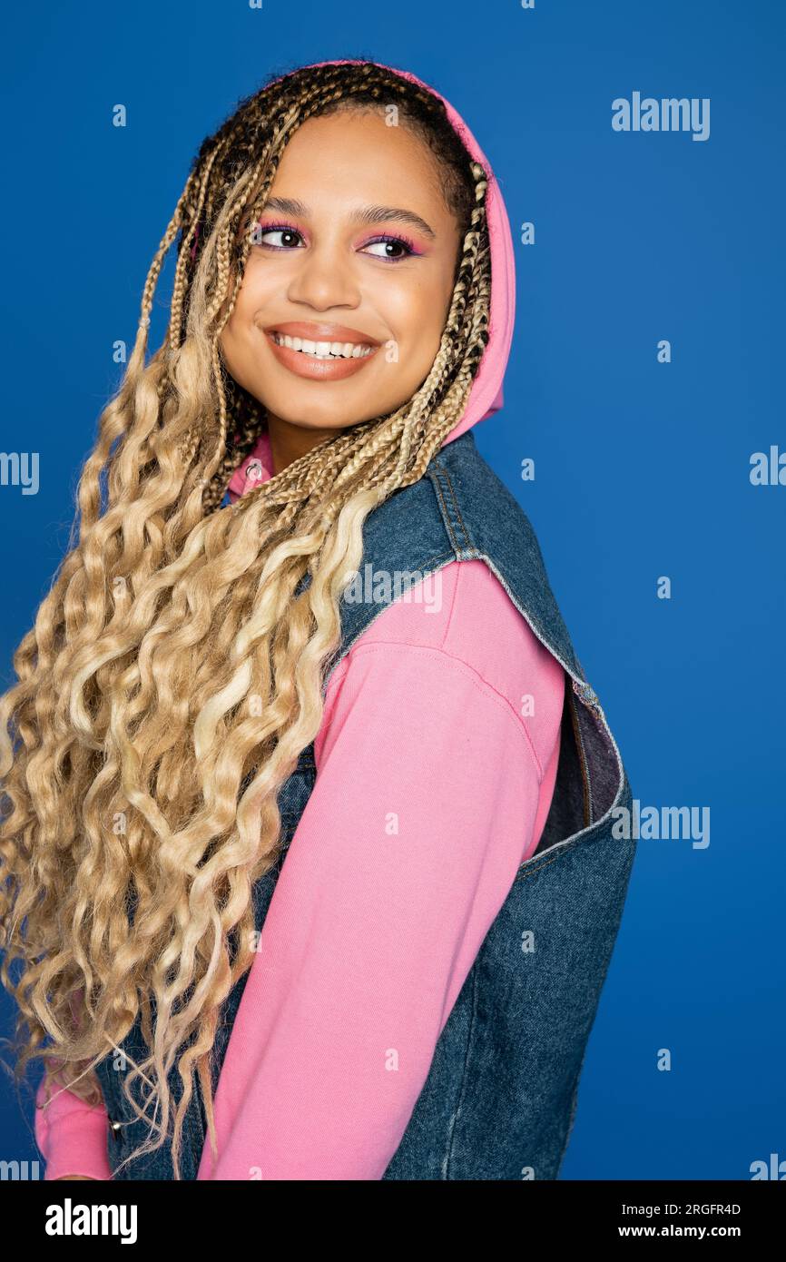 portrait of african american woman in pink hood smiling and looking ...