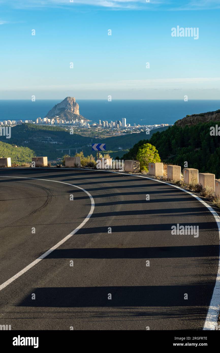 Empty winding mountain road, Calpe village at background, Alicante ...
