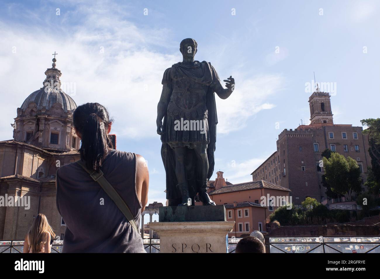 Rome, Italy. 08th Aug, 2023. A girl takes a photo of the statue of ...