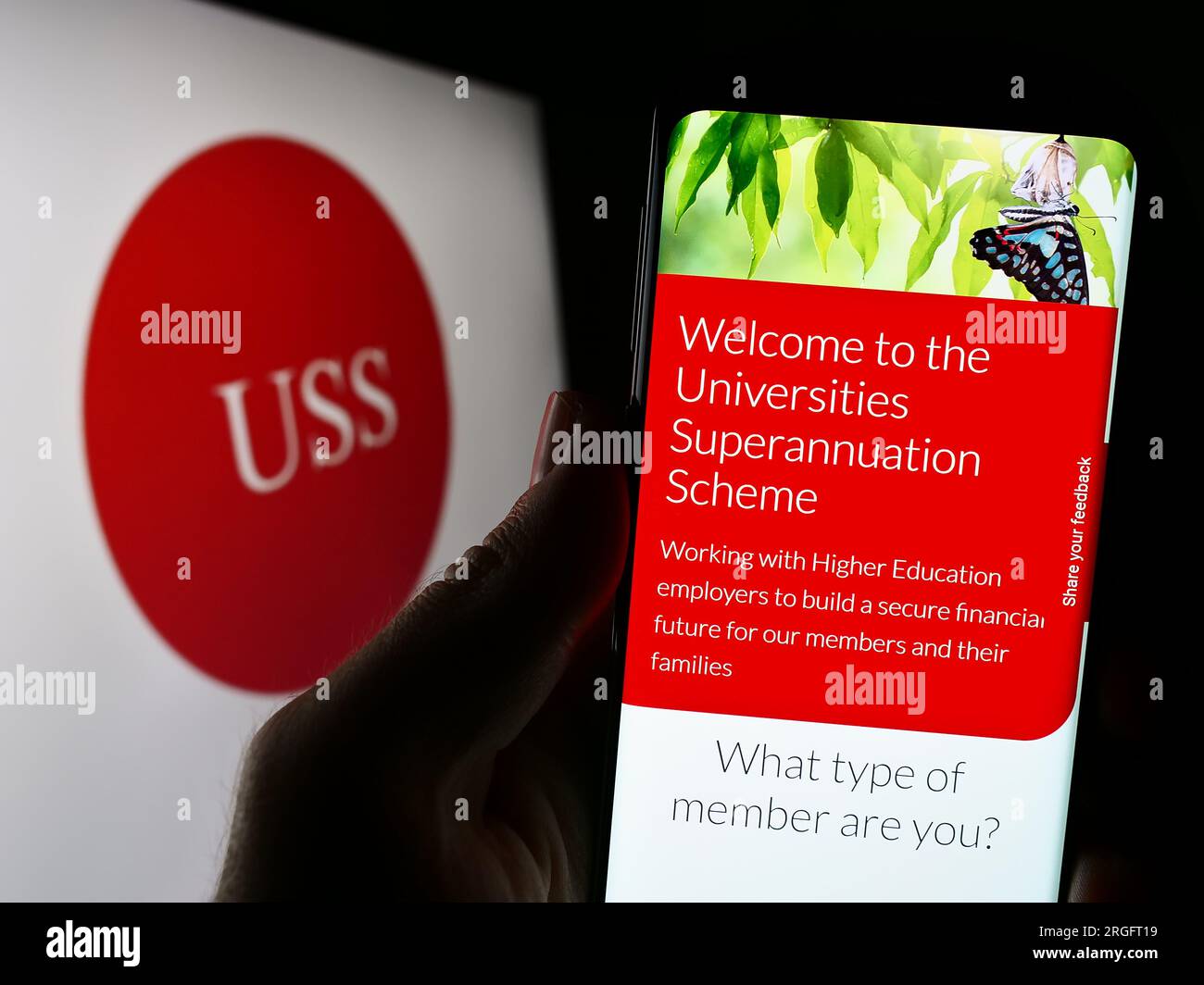 Person holding smartphone with website of Universities Superannuation ...