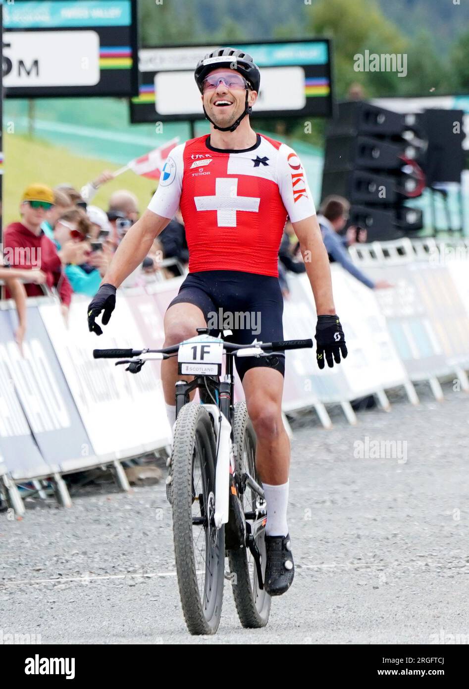 Switzerland's Nino Schurter celebrates victory as he crosses the finish ...