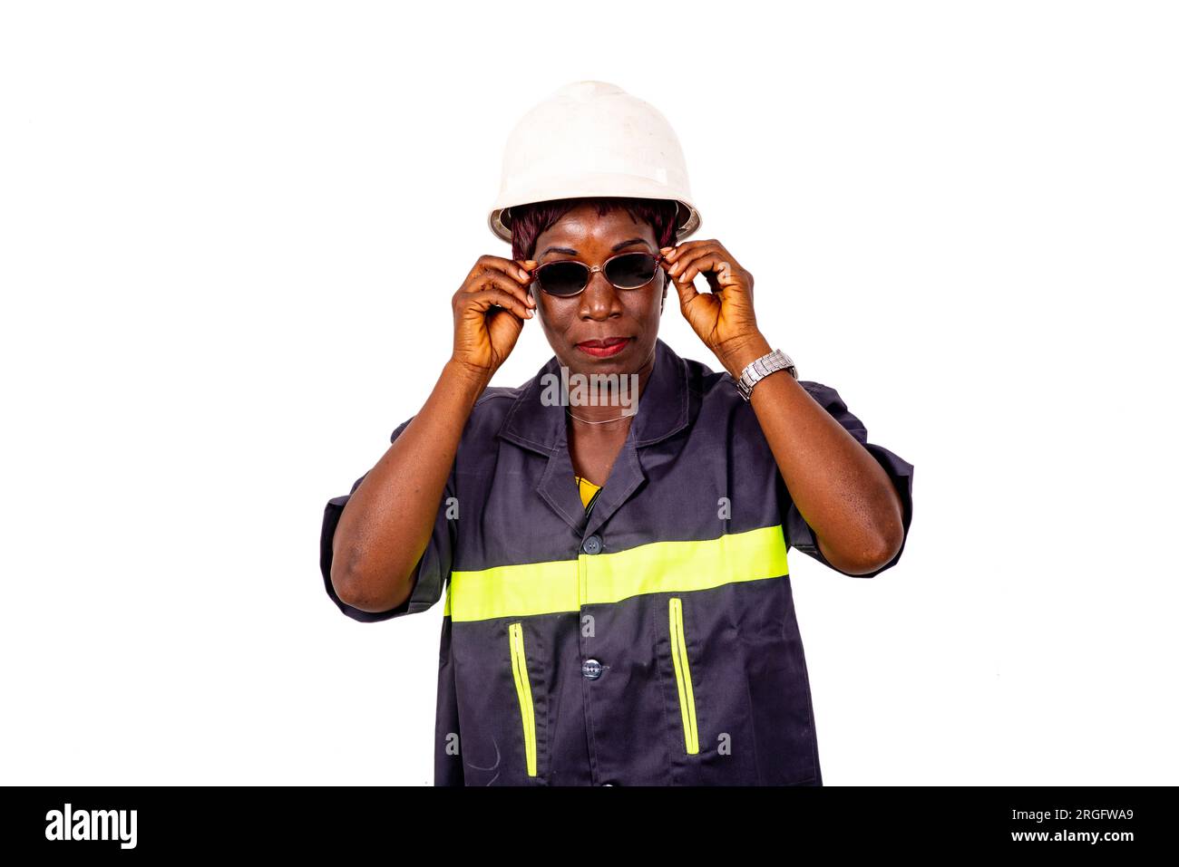 portrait of a beautiful female engineer wearing work uniform and white ...
