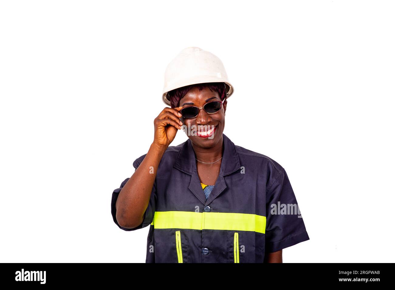 portrait of a beautiful female engineer wearing work uniform and white ...