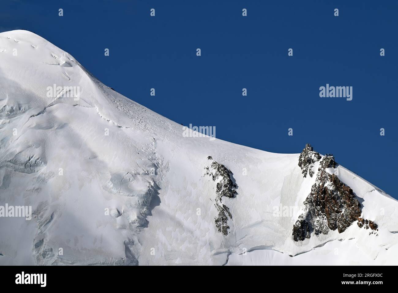 snow covered Bosses ridge of Mont Blanc with Vallot hut and observatory ...