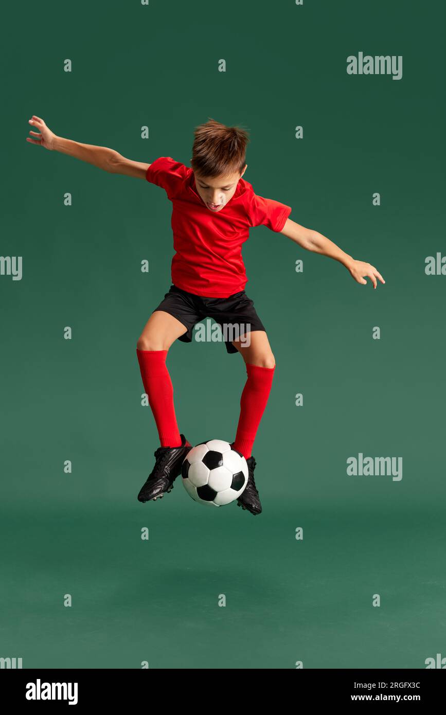Future football player. Little boy, child in sportswear posing, playing ...