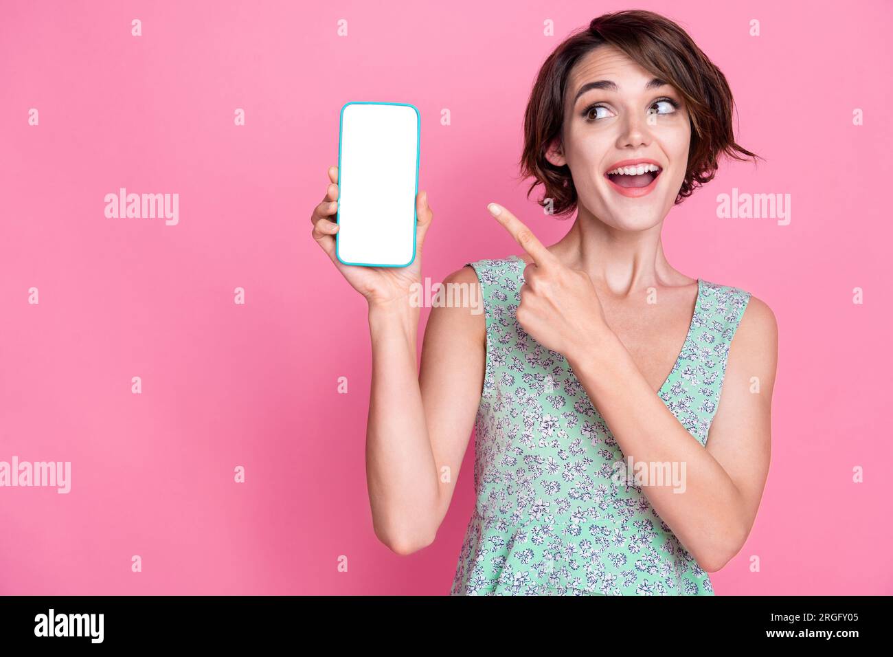 Photo of young promoter woman direct finger looking interested phone ...