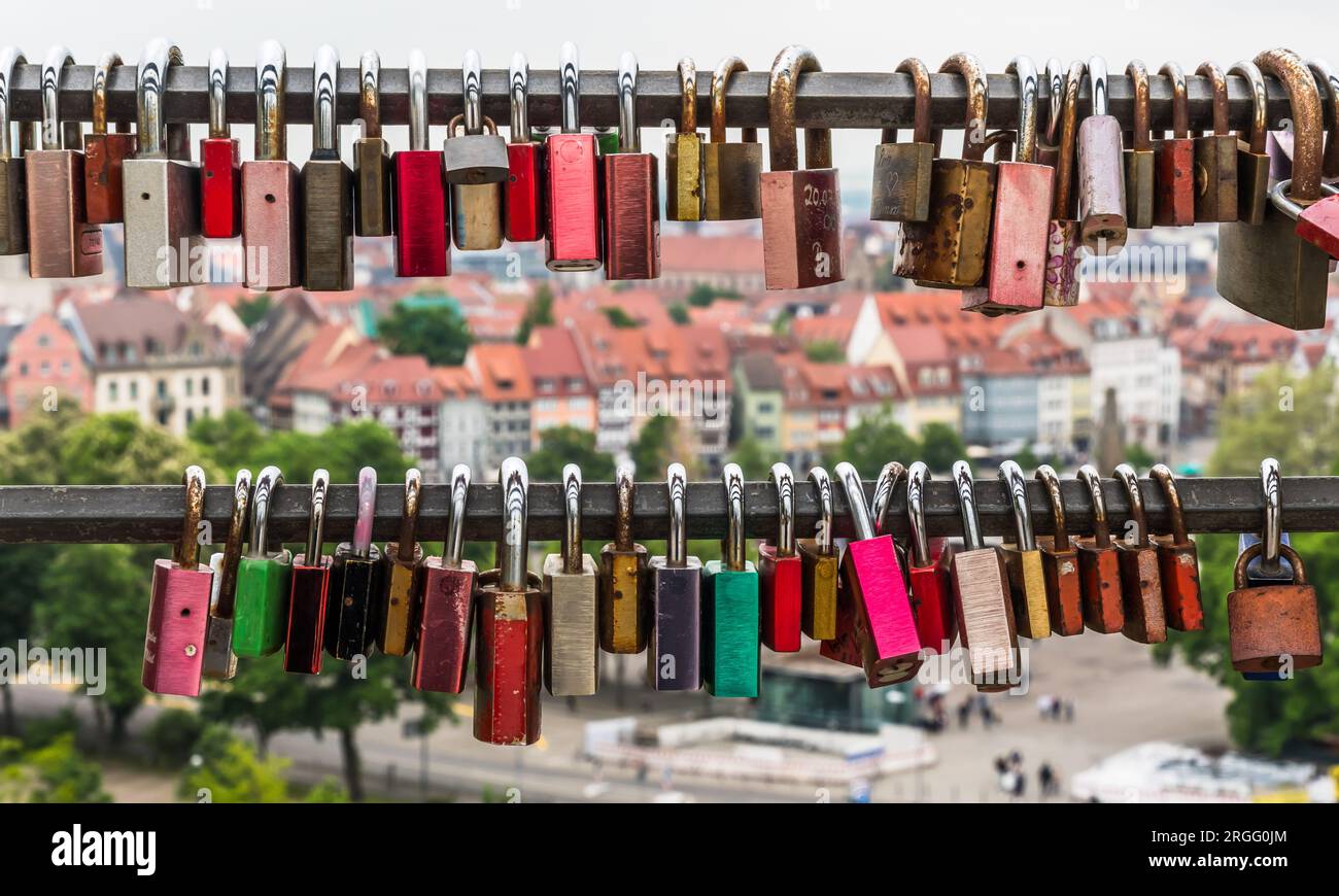 Two poles with love locks, in the background houses of Erfurt, Germany ...