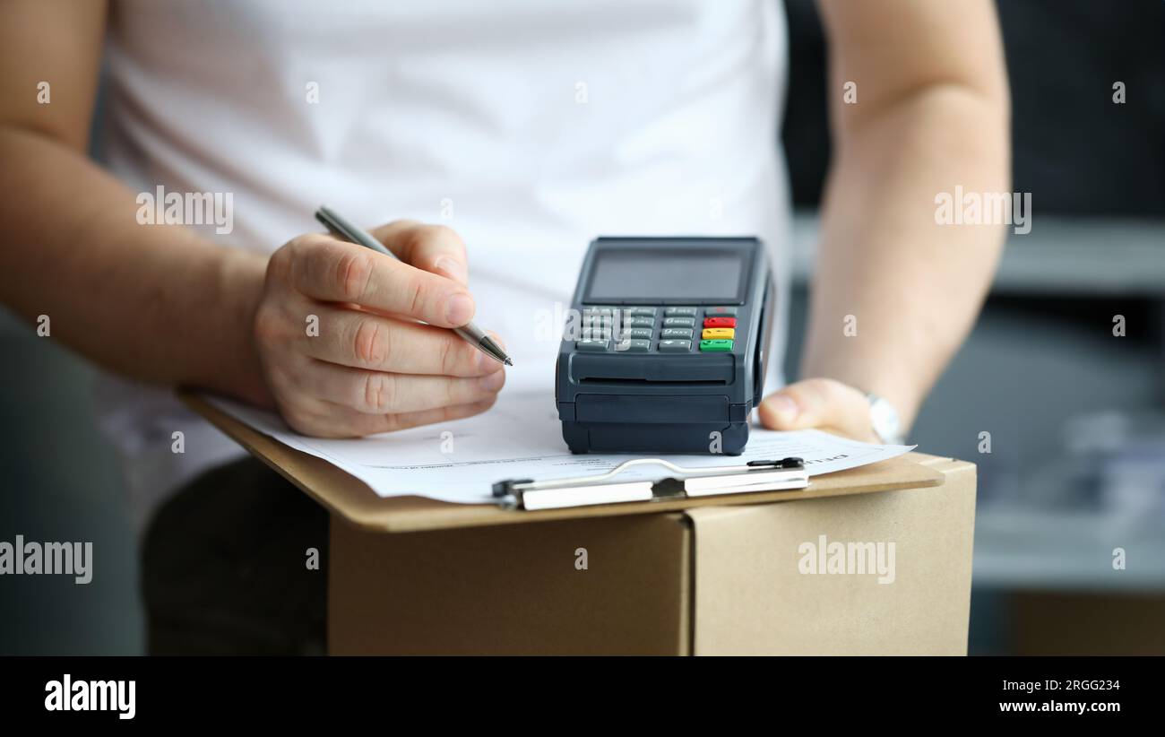 Male hand sign order receipt close up and pay by terminal Stock Photo ...