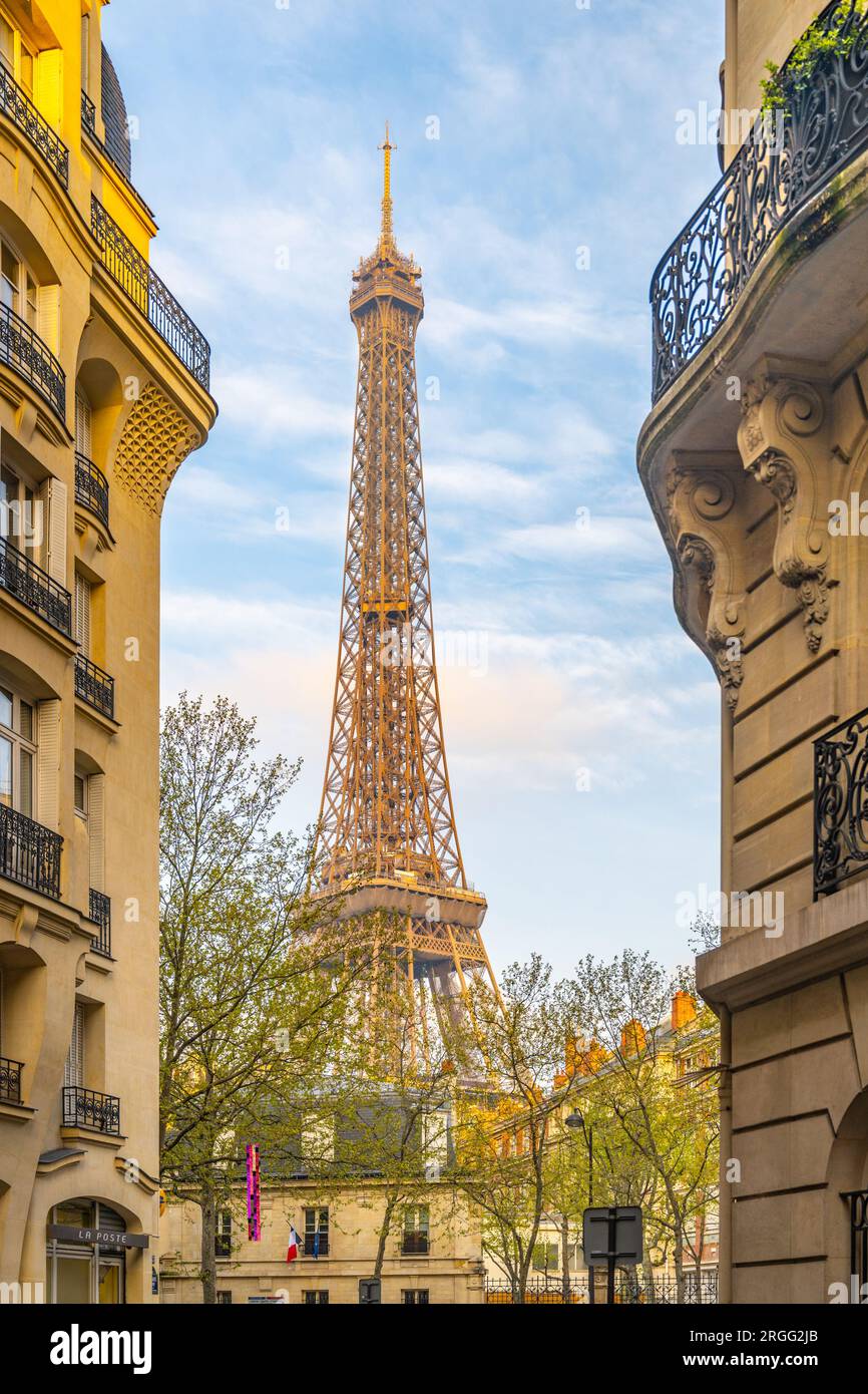 View of the Eiffel Tower from a nearby street full of residential ...