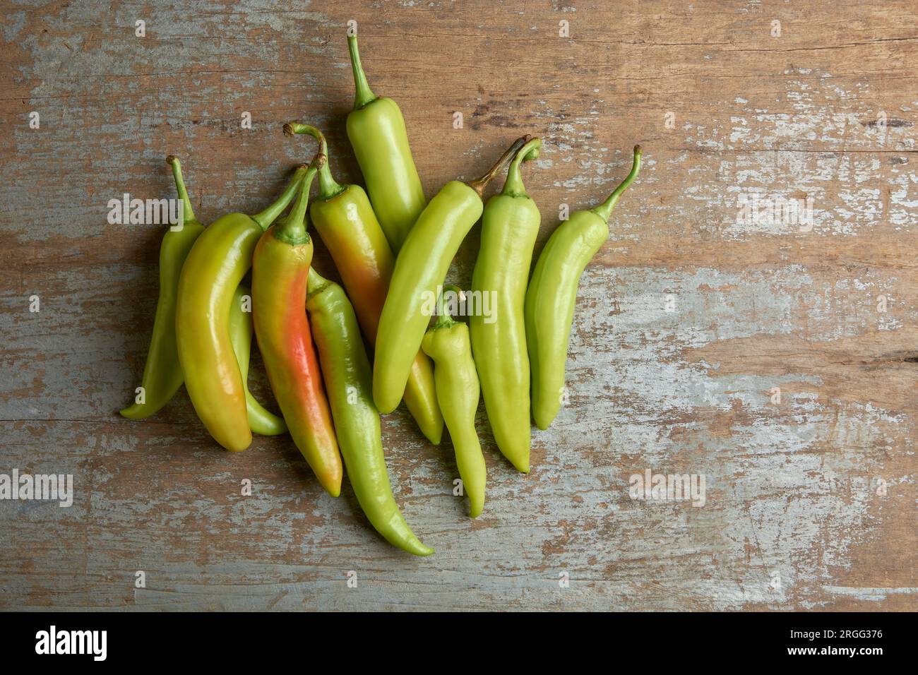 pile of banana peppers on table top, capsicum annuum, popular chili ...