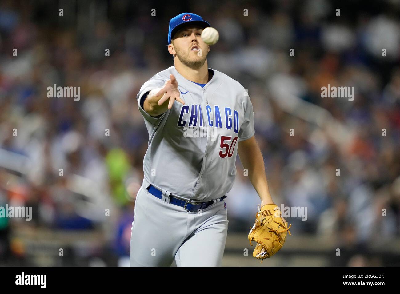 Chicago Cubs starting pitcher Jameson Taillon (50) flips the ball to ...