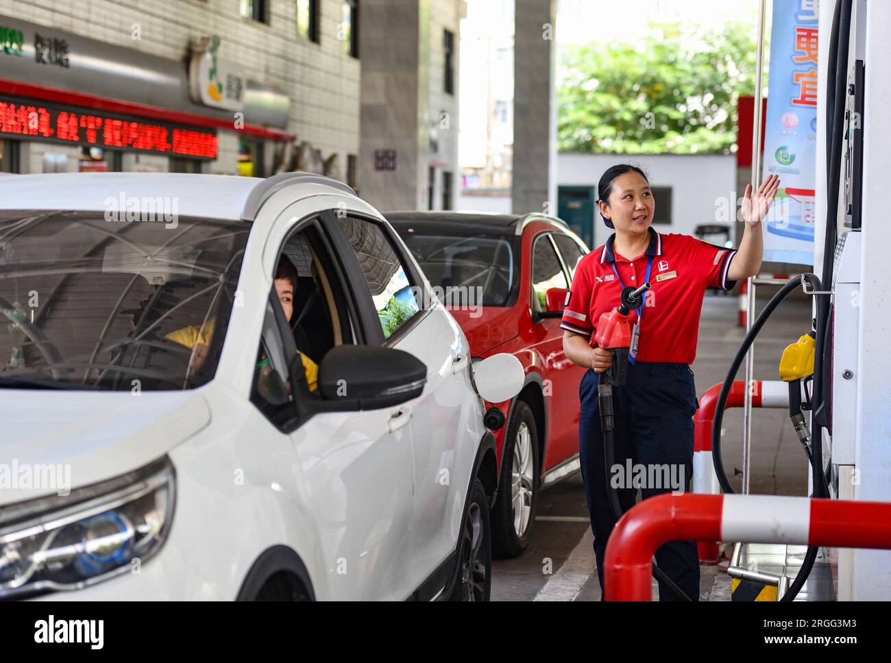 Fuyang, China. 09th Aug, 2023. A female worker at a gas station ...