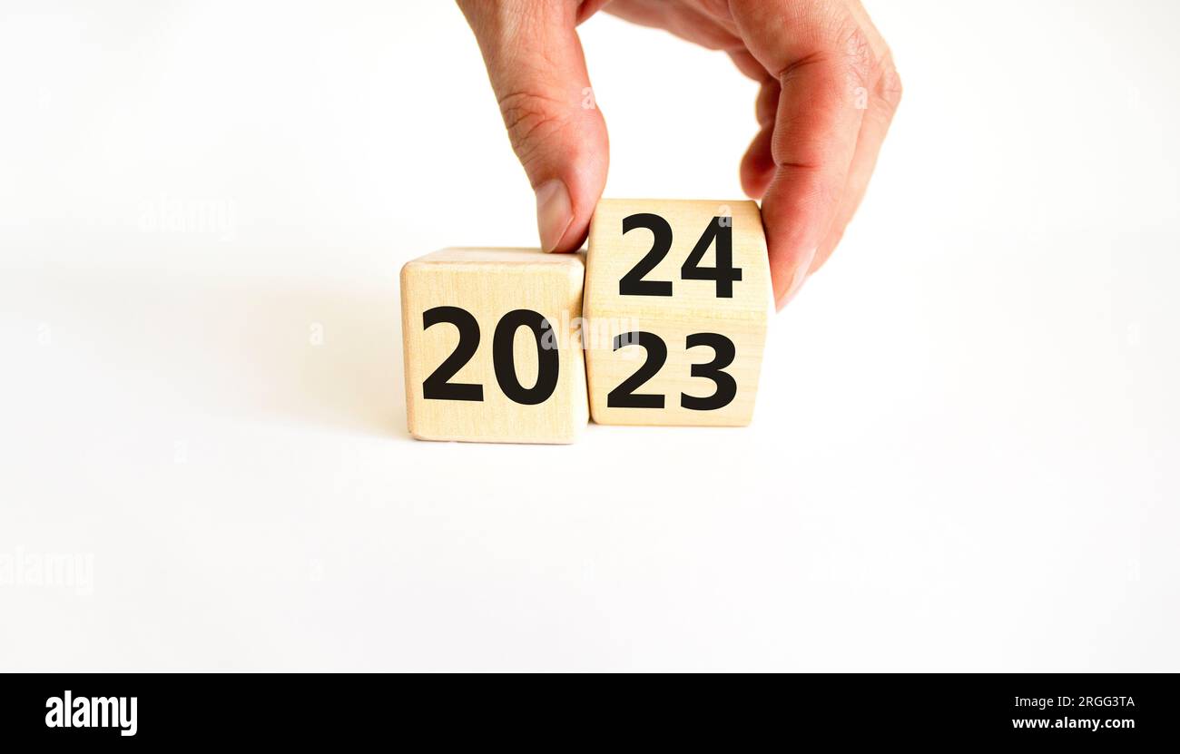 Business concept of 2024 new year symbol. Businessman turns a wooden ...