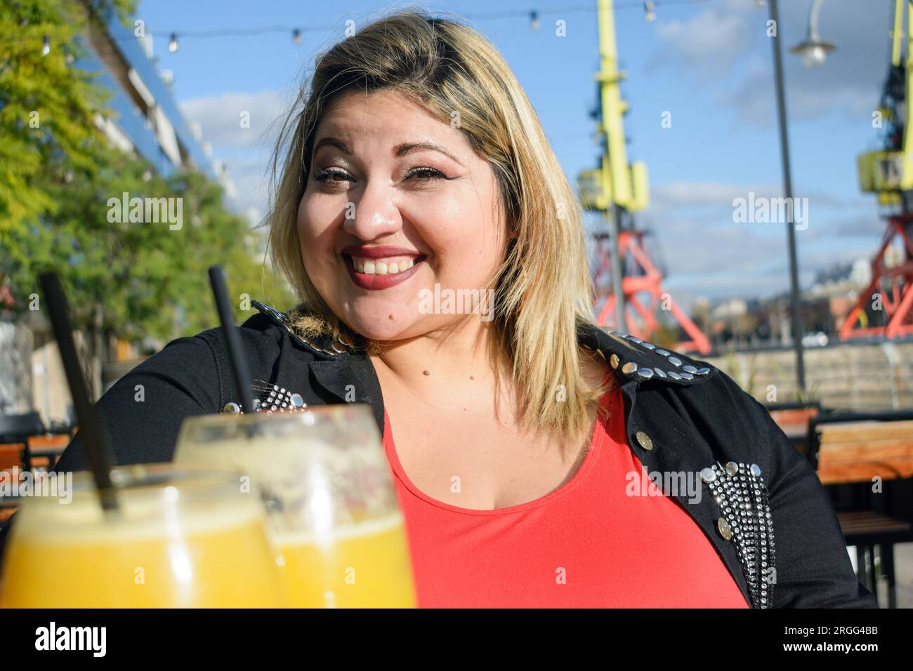 front view young plus size latin woman smiling and making toast with ...