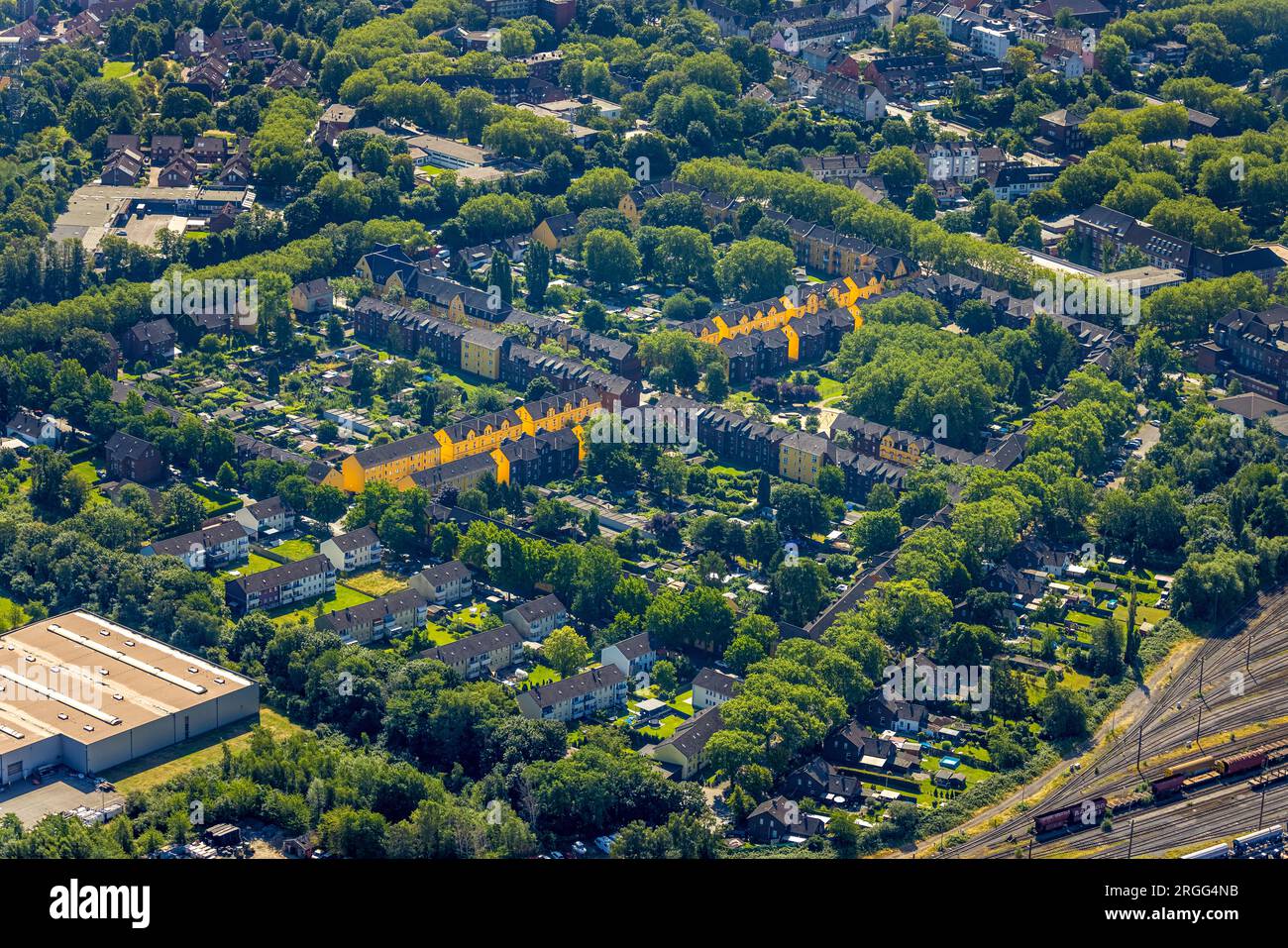 Aerial view, housing estate row houses with colorful yellow house ...