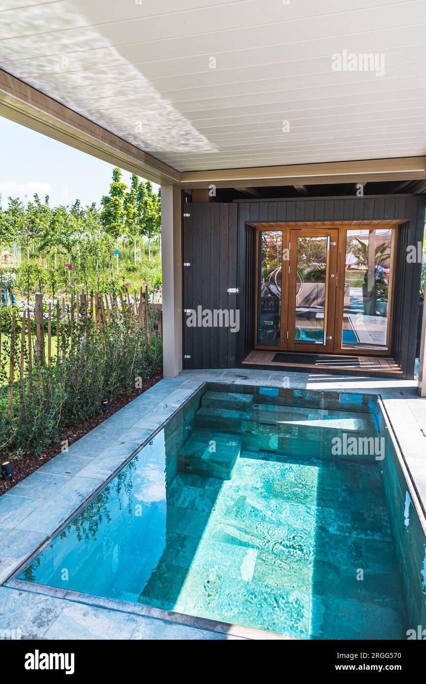 Modern swimming pool and sauna in a garden Stock Photo - Alamy