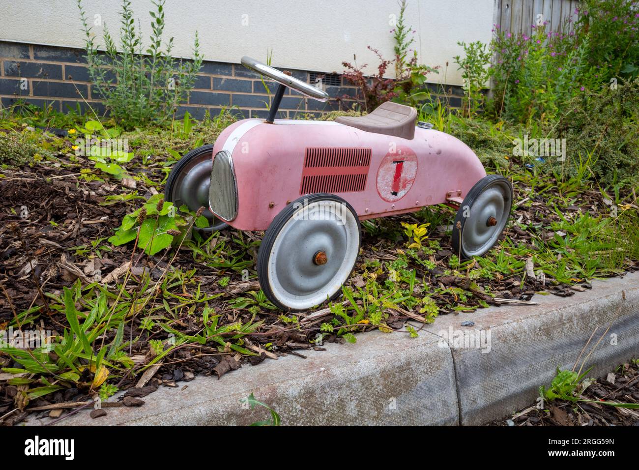 Child vintage pink push along racing card Stock Photo - Alamy