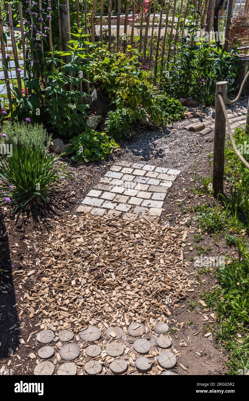 Garden path made of natural wooden planks, stones, gravel. Healthy ...