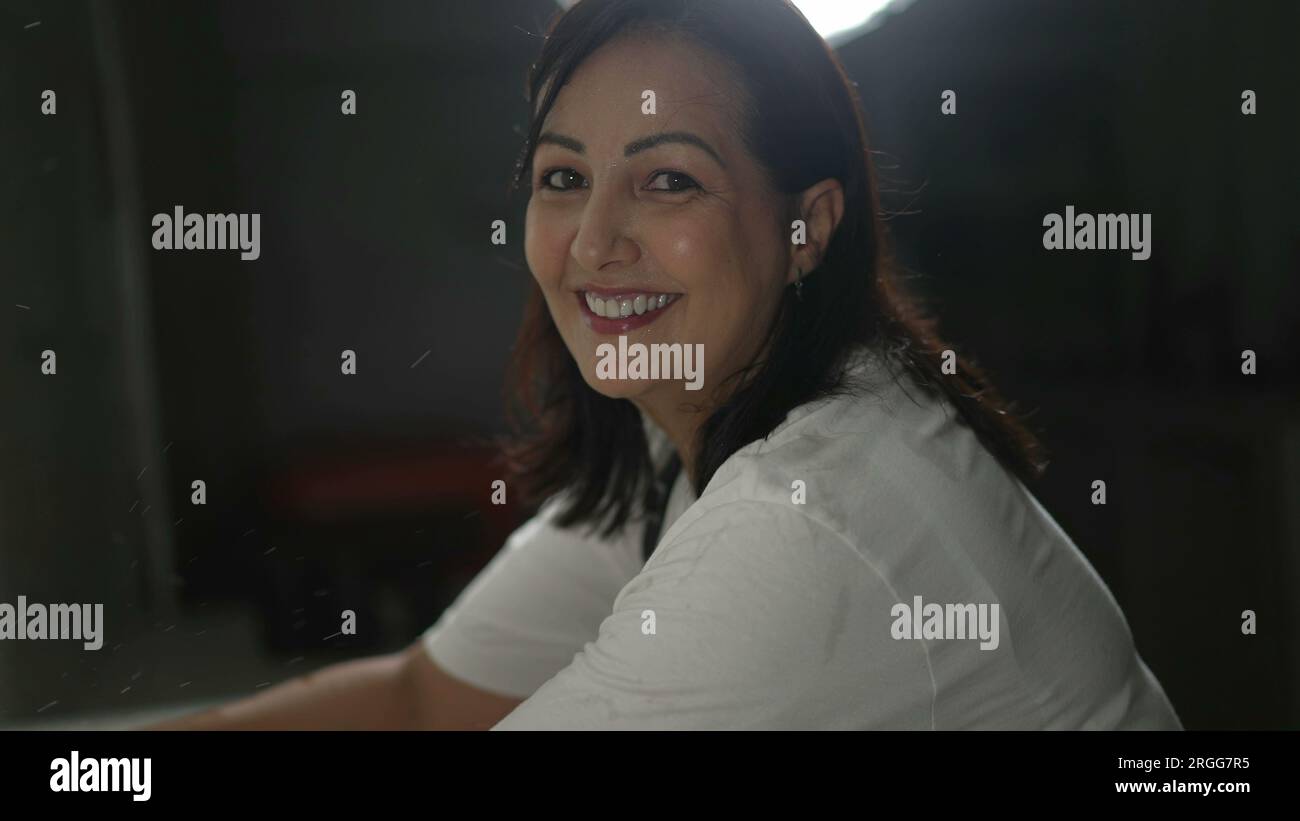 Happy Brazilian female Pet Shop owner washing Beagle Dog with shampoo. Woman bathing canine ...
