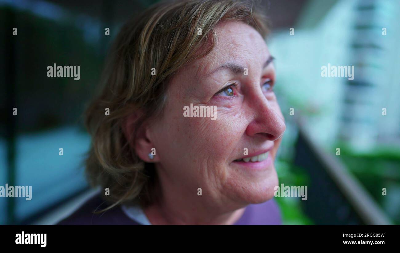 One senior woman closing eyes in contemplation. A meditative older lady ...