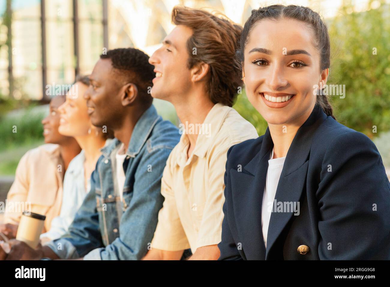 Beautiful young woman spending time with her friends multicultural students Stock Photo - Alamy