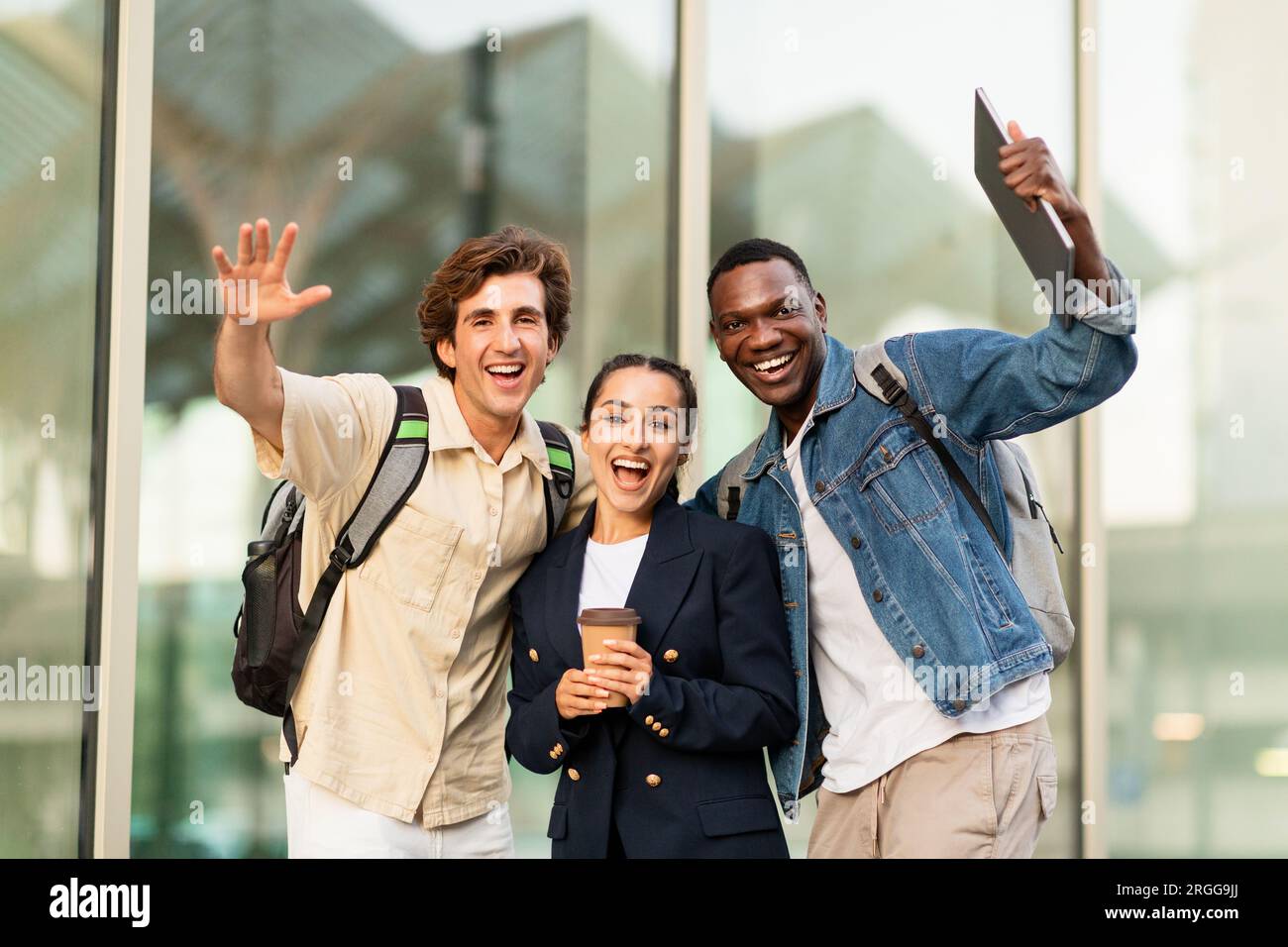 Group smiling students waving hi-res stock photography and images - Alamy