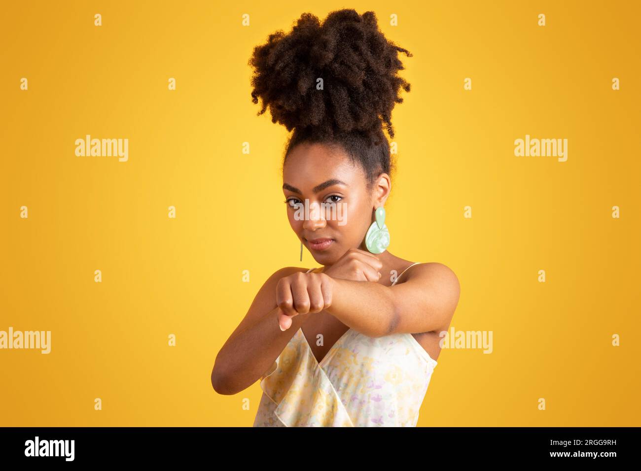 Strong confident serious millennial black lady doing punch, fist fight ...