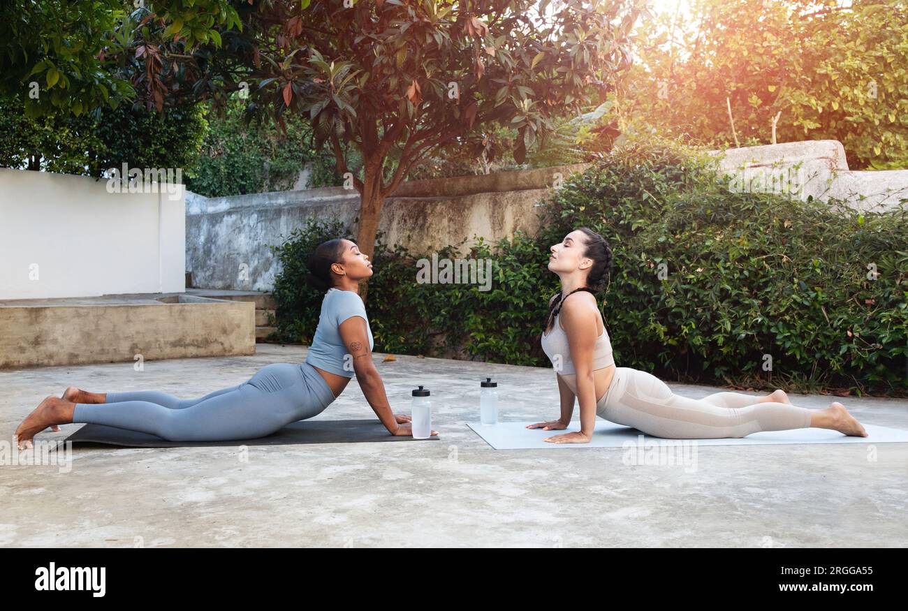 Calm young arab, african american women athletes in sportswear practice ...