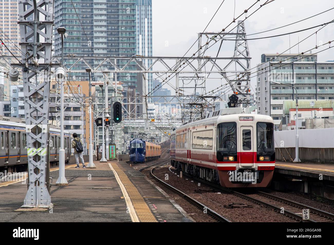 Osaka, Japan- April 8, 2023; View down the railroad tracks lined with ...