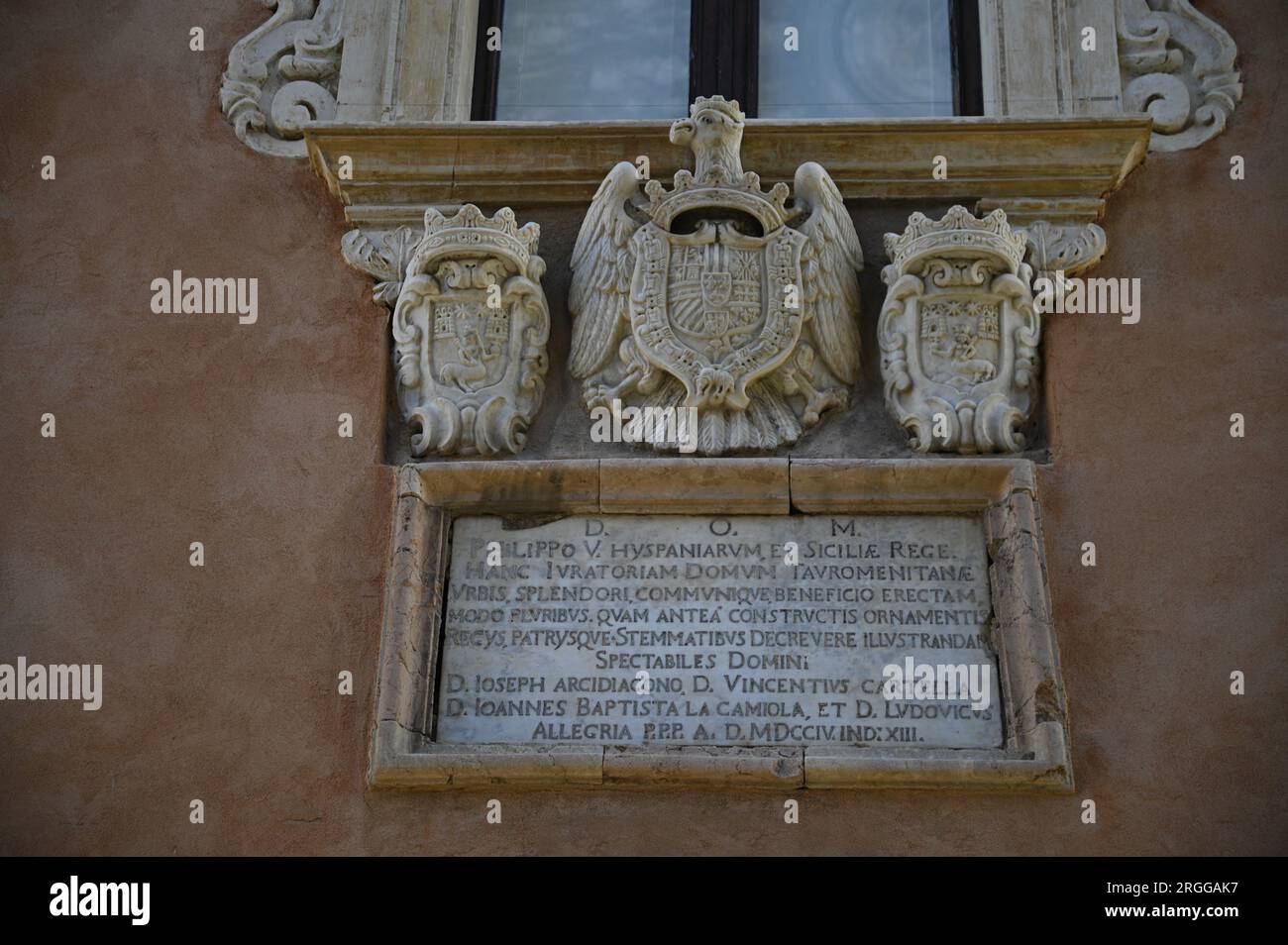 Marble carved inscription and sculpted religious symbols, crest and ...