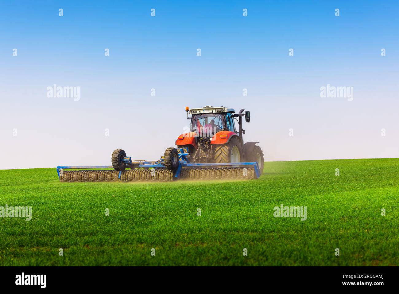 Tractor with a roller tillage on spring field. Soil rolling supports ...